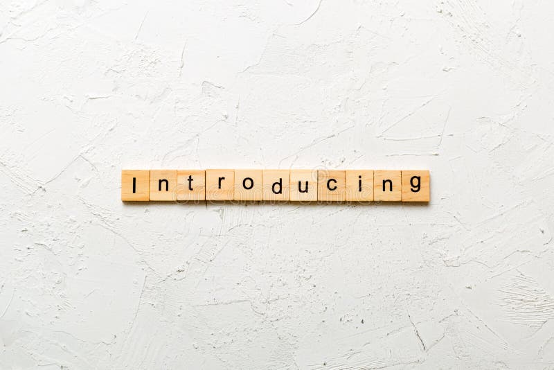 Introducing Word Written on Wood Block. Introducing Text on Table ...