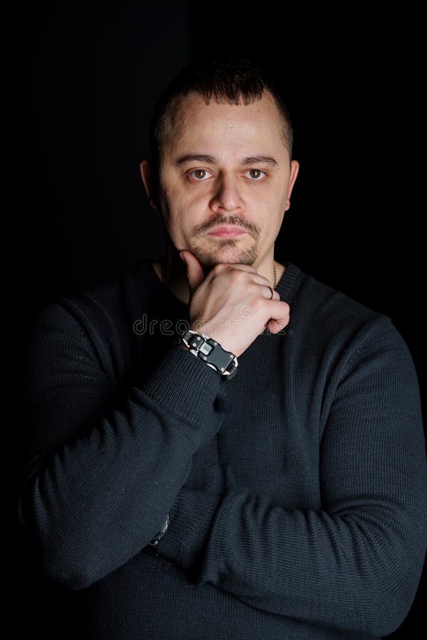 Introspective Man in Black Background with Thoughtful Expression Stock ...