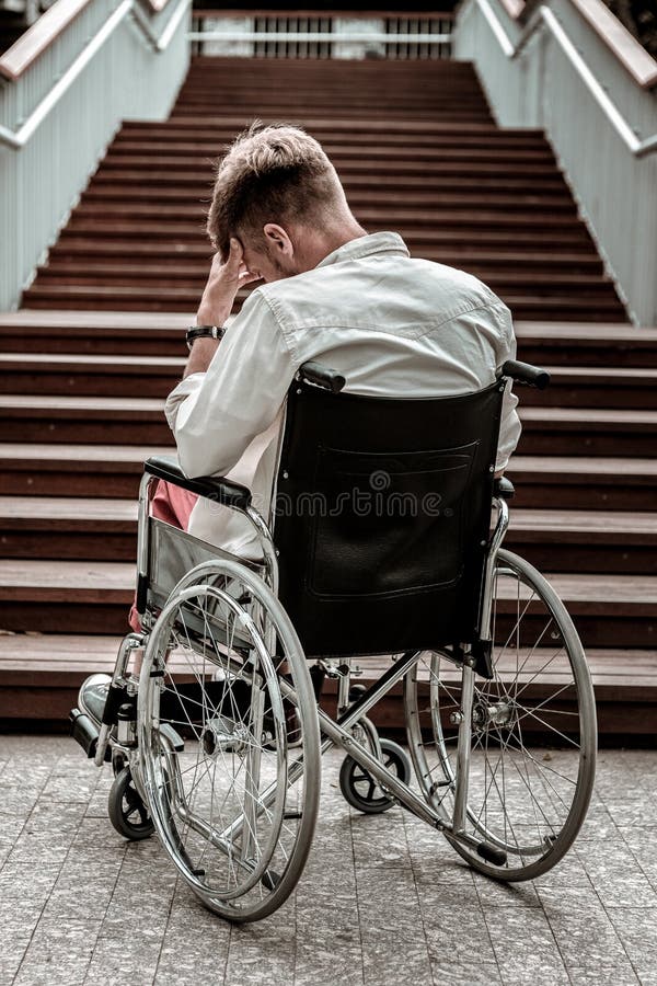 Unhappy Disabled Man Sitting in Wheelchair and Facing a Problem Stock ...