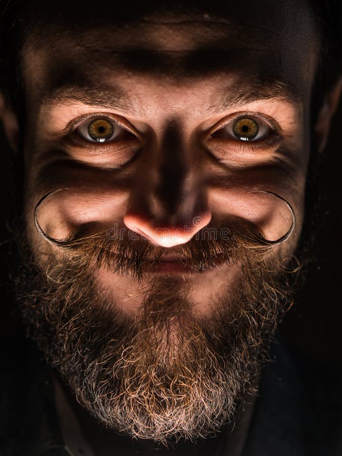 Inventor Hipster with Beard and Mustages in the Dark Room. Smiling ...