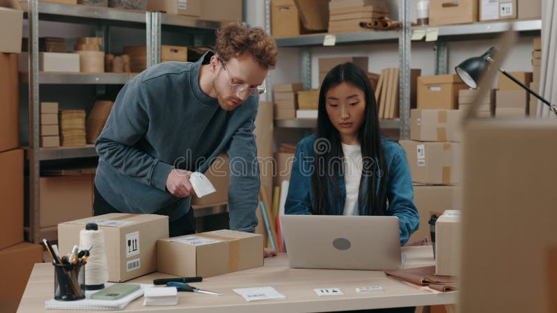Inventory Managers Scans Cardboard Box with Barcode Scanner in the ...