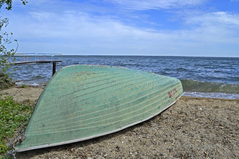 Inverted Boat on the Shore of a Large Lake . Stock Photo - Image of ...