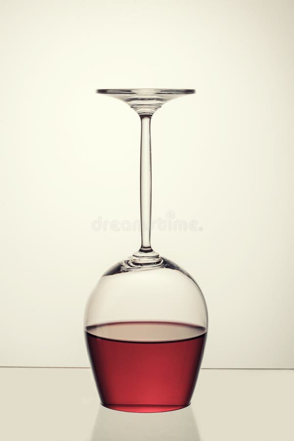 Inverted Glass of Red Wine on a Light Background Stock Photo - Image of ...
