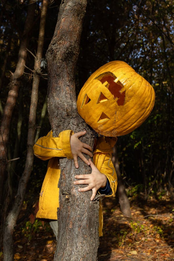 Inverted Pumpkin instead of a Head for a Child Standing Behind a Tree ...