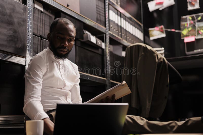 Investigator Reading Forensic Report and Checking Information on Laptop ...