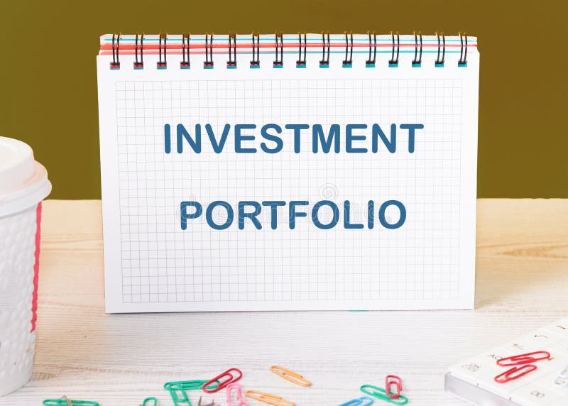 INVESTMENT PORTFOLIO Words Written in a Checkered Notebook on the Table ...