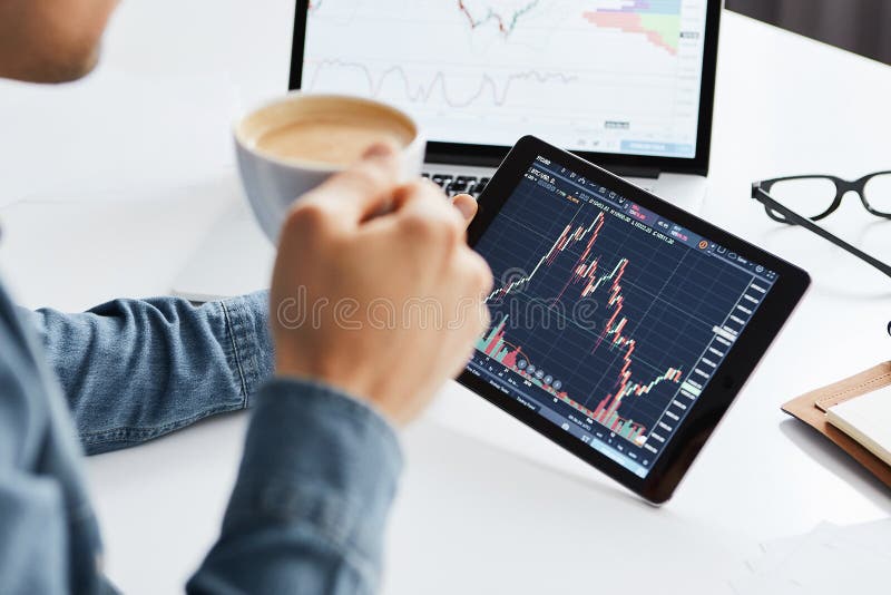 Investor Watching the Change of Stock Market on Tablet. Stock Photo ...