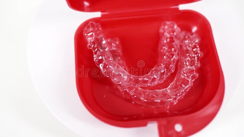 Invisalign Clear Aligner in Red Container Rotates Against Light Effects ...