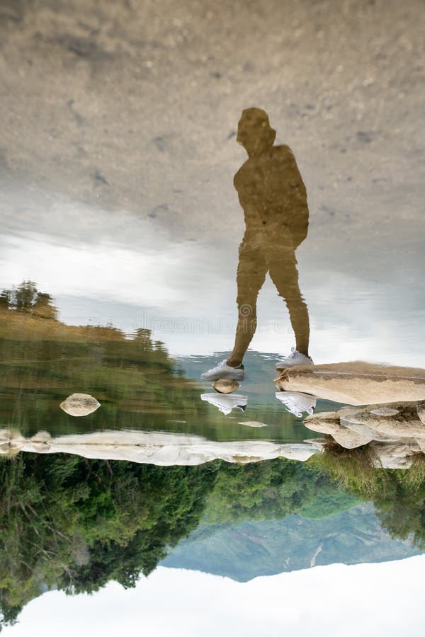 Invisible Man in White Sneakers Reflected on Water Surface Stock Photo ...