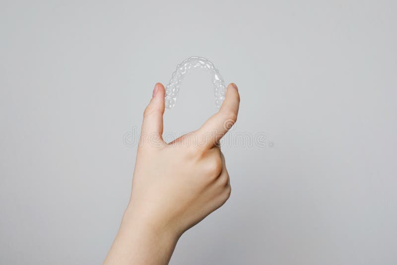 Invisible Orthodontics Cosmetic Brackets in Human Hand, Tooth Aligners ...