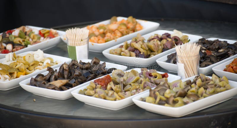 An Inviting Display of Various Marinated Olives in White Dishes, Ready ...