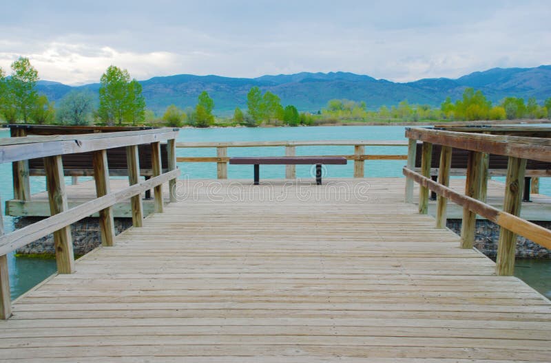 Inviting Lake Pier with View of Purple Mountains Stock Image - Image of ...