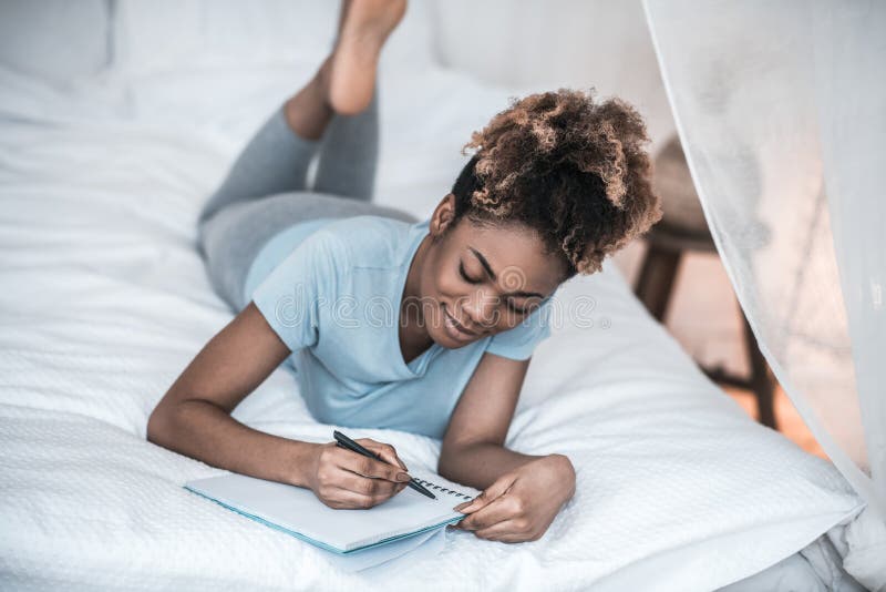 Involved Woman Lying On Bed Writing In Notebook Stock Image Image Of