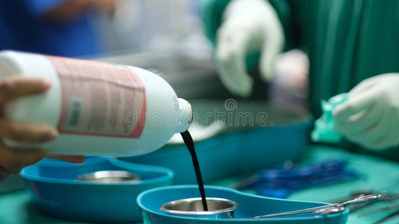 Iodine Being Poured into Gallipot Under Aseptic Precaution. Stock Photo ...