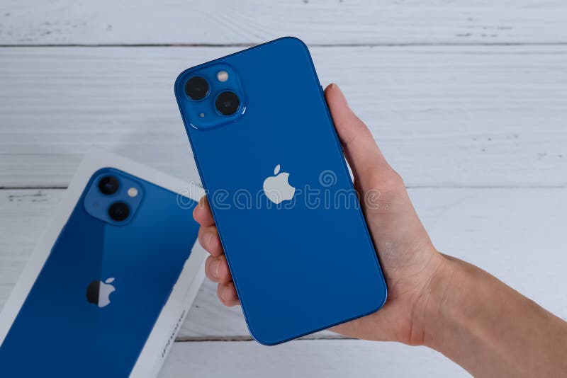 IPhone 13 in blue editorial photography. Image of screen - 230699867