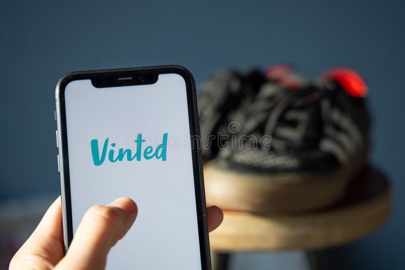 Iphone with Vinted Logo on Screen with Hand in Front of Style Shoes ...