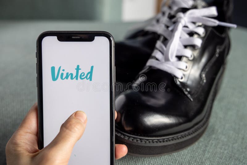 Iphone with Vinted Logo on Screen with Hand in Front of Style Shoes ...
