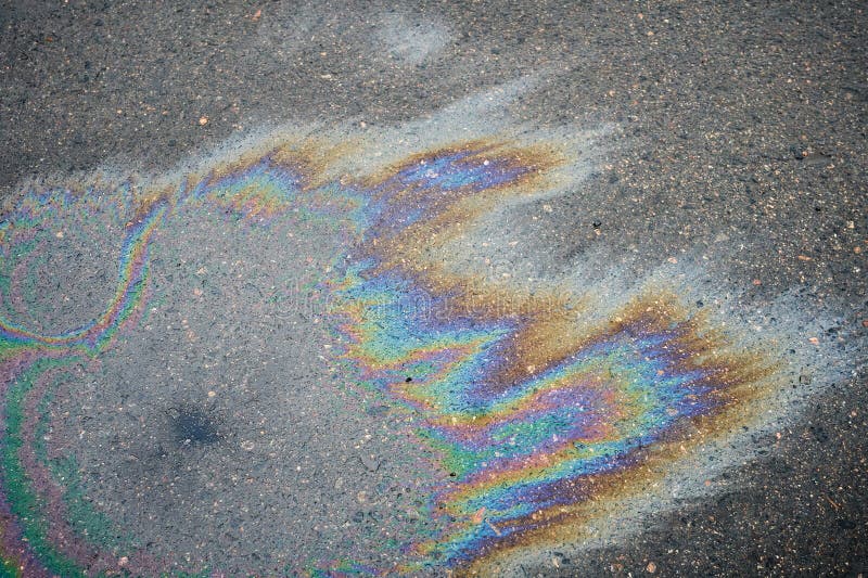 Iridescent Oil Spill Forms Vibrant Rainbow Patterns on Rough Asphalt ...
