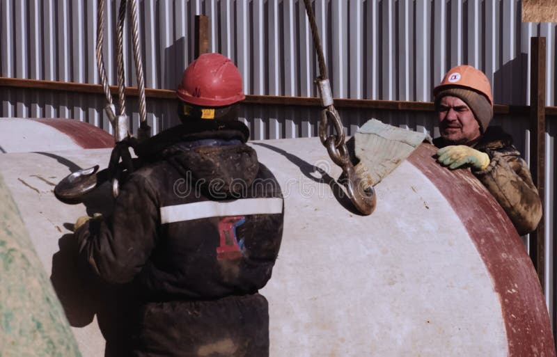 Slinger at Work. Stroply Cargo. Worker in a Helmet Editorial Image ...