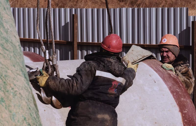 Slinger at Work. Stroply Cargo. Worker in a Helmet Editorial Stock ...