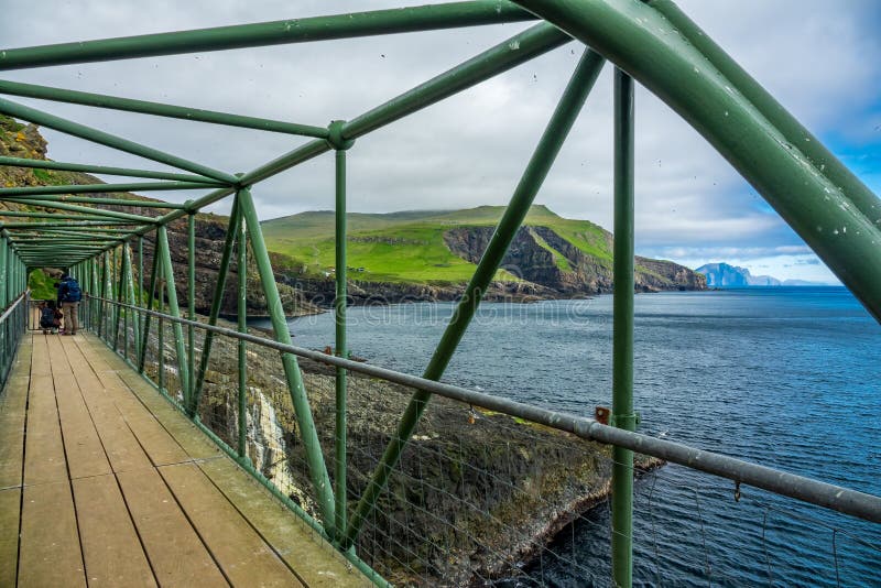 Iron Bridge in the Mykines Island with Unrecognizable Tourists Stock ...