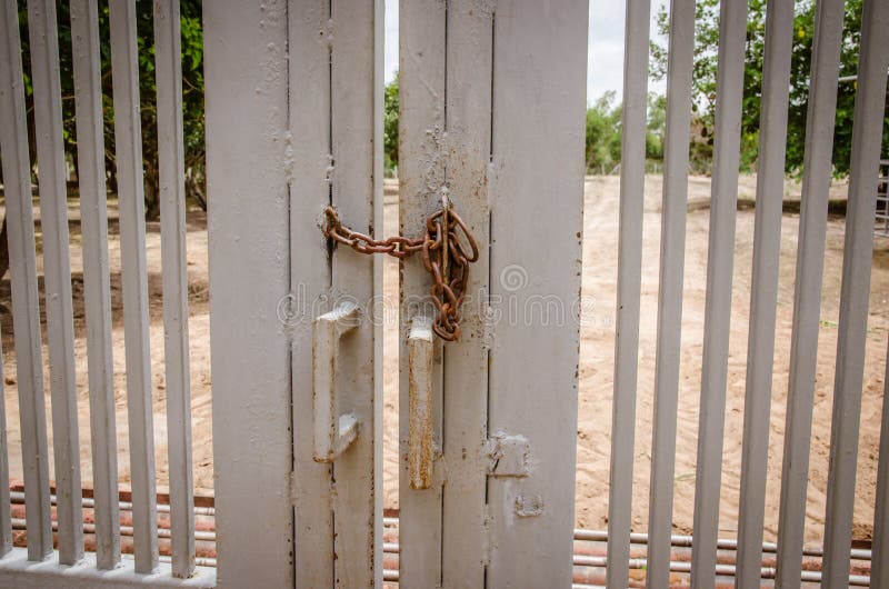 Iron Chain on a Barred Double Gate Stock Image - Image of plated, plate ...
