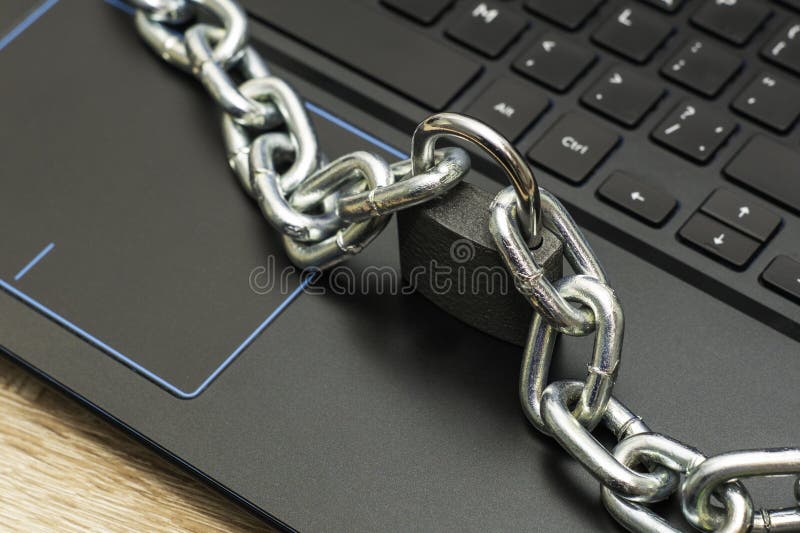 An Iron Chain Fastened with a Padlock on a Computer Keyboard the ...