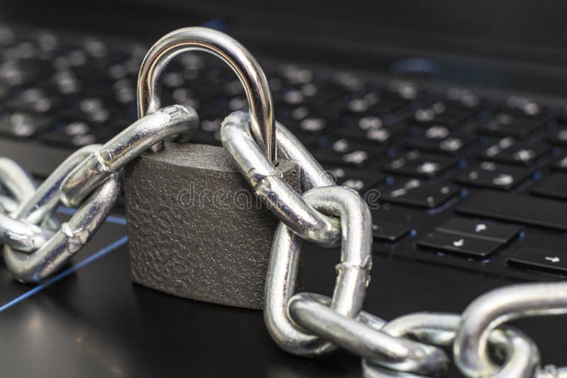 An Iron Chain Fastened with a Padlock on a Computer Keyboard the ...