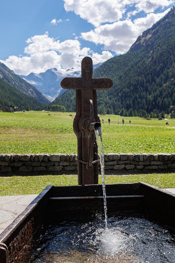 Iron Cross-shaped Fountain with Flowing Water Set in a Mountain ...