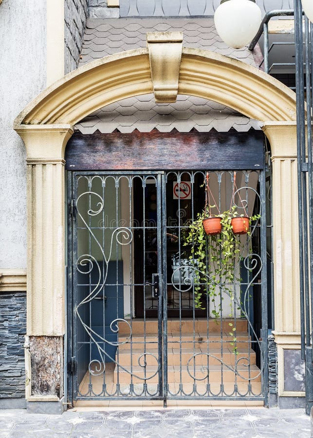 Iron Forged Door with Decorative Elements on the Facade of the Building ...