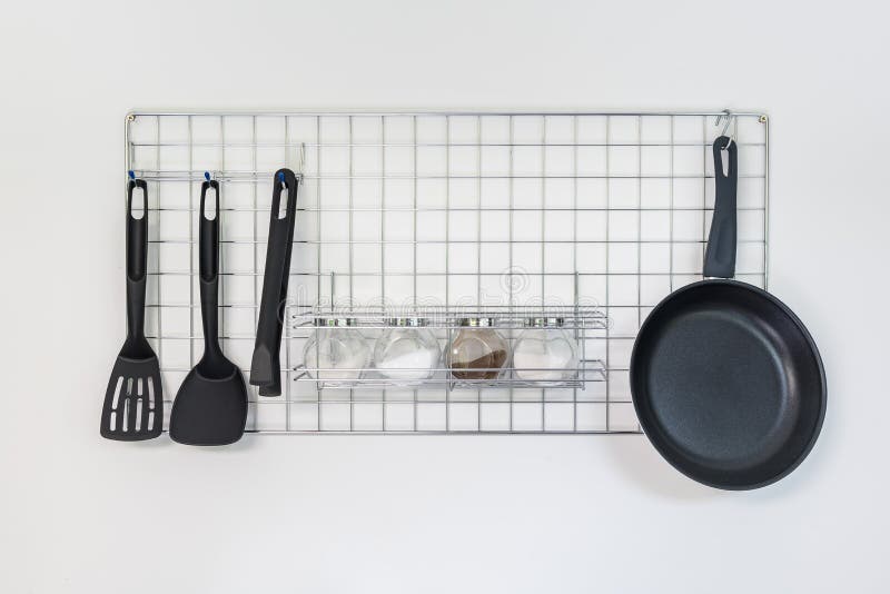 Iron Frying Pan and Utensils Hanging on the Wall Stock Photo - Image of ...