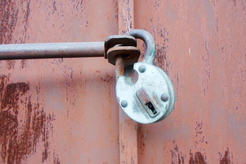Iron Gate Covered with Rust and a Large Lock on the Gate. Texture of a ...