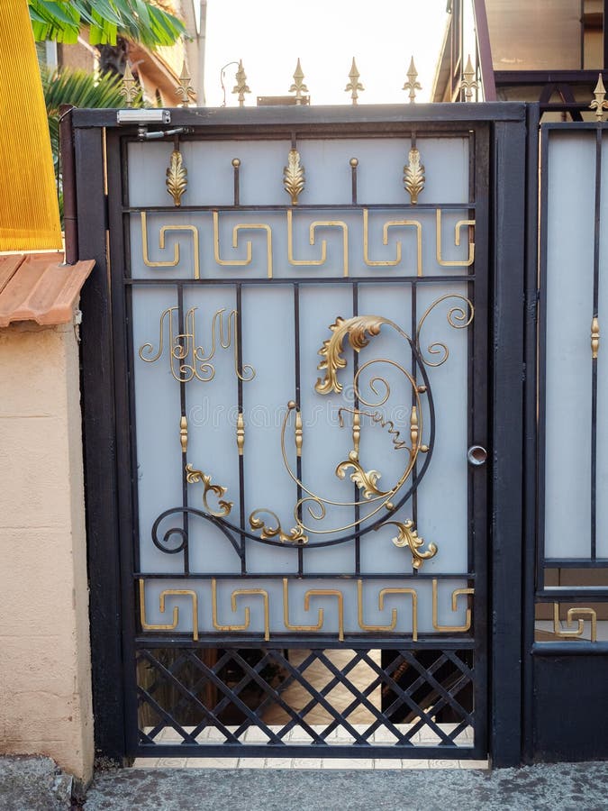 Iron Gate with Forging Elements in Black and Gold Stock Photo - Image ...