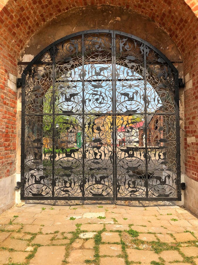 Iron Gate with a Pattern on the Background of a Stone Wall Stock Image ...
