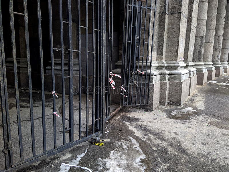 Iron Gate with Torn and Warning Red and White Tapes. Stock Photo ...