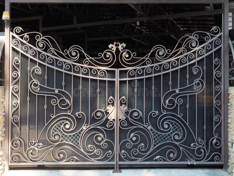 Iron Gate with Wrought Iron Monogram Pattern in Front of a Covered ...