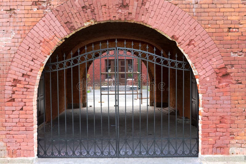 Iron Gates in the Old Brick Wall. Stock Photo - Image of garden ...