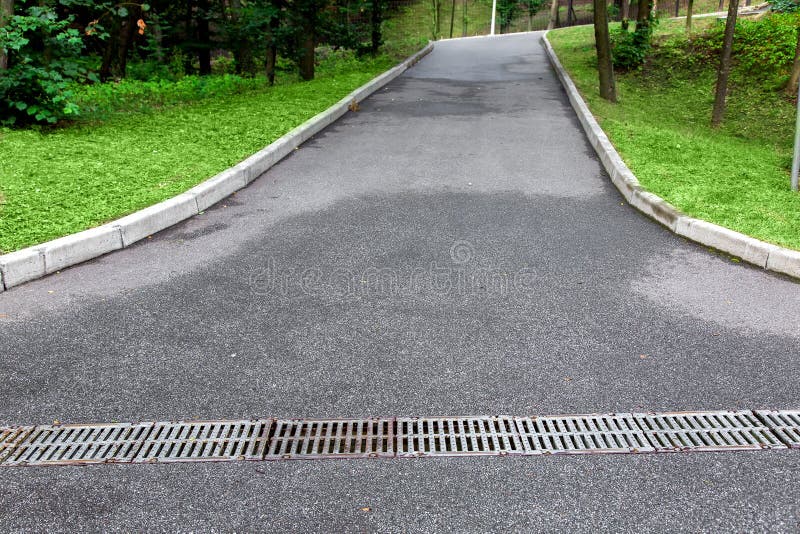 Iron Grid Drainage System on an Asphalt Road. Stock Photo - Image of ...