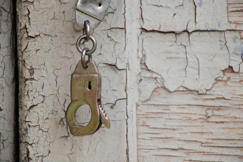 Iron Handcuffs Hanging on a Hook on the Wall of the House Close Up ...