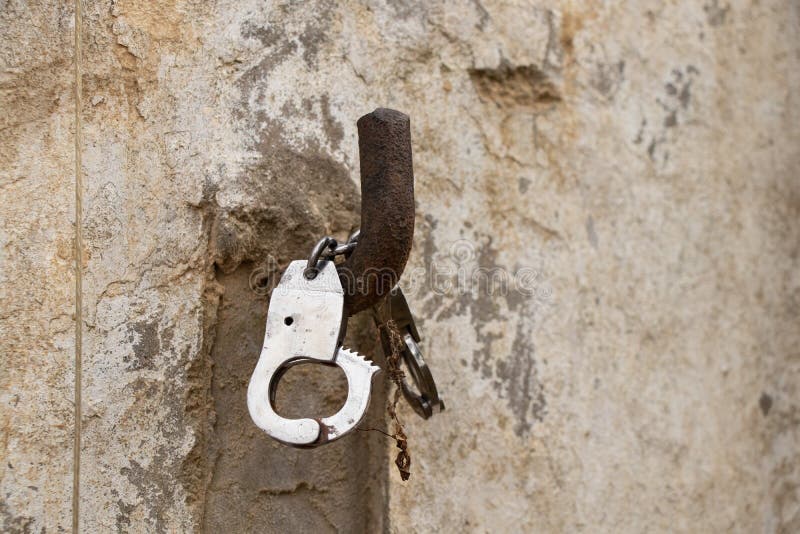 Iron Handcuffs Hanging on a Hook on the Wall of the House Close Up ...