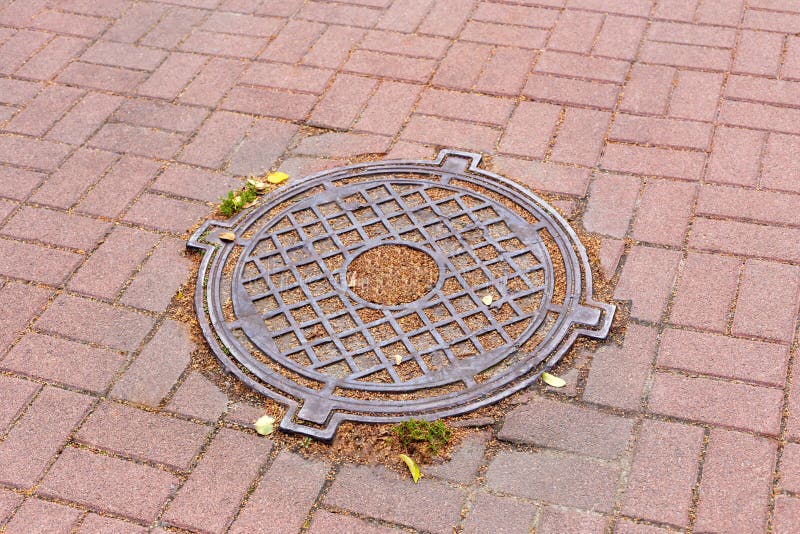 Iron Hatch on the Ground among the Tiles Close Up Stock Photo - Image ...