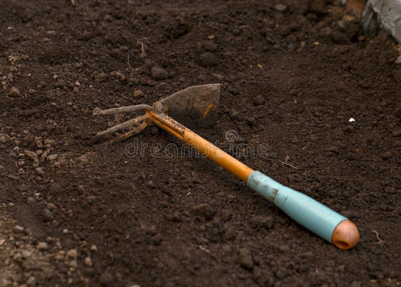 Iron Hoe with Plastic Handle Lies on Black Ground Stock Image - Image ...