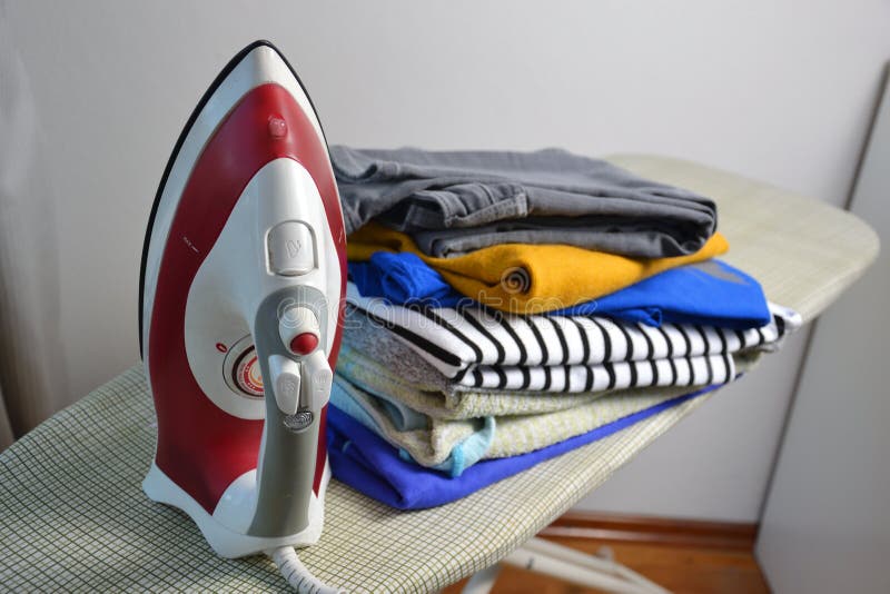 An Iron with Ironed Laundry Stock Image - Image of flatiron, closeup ...