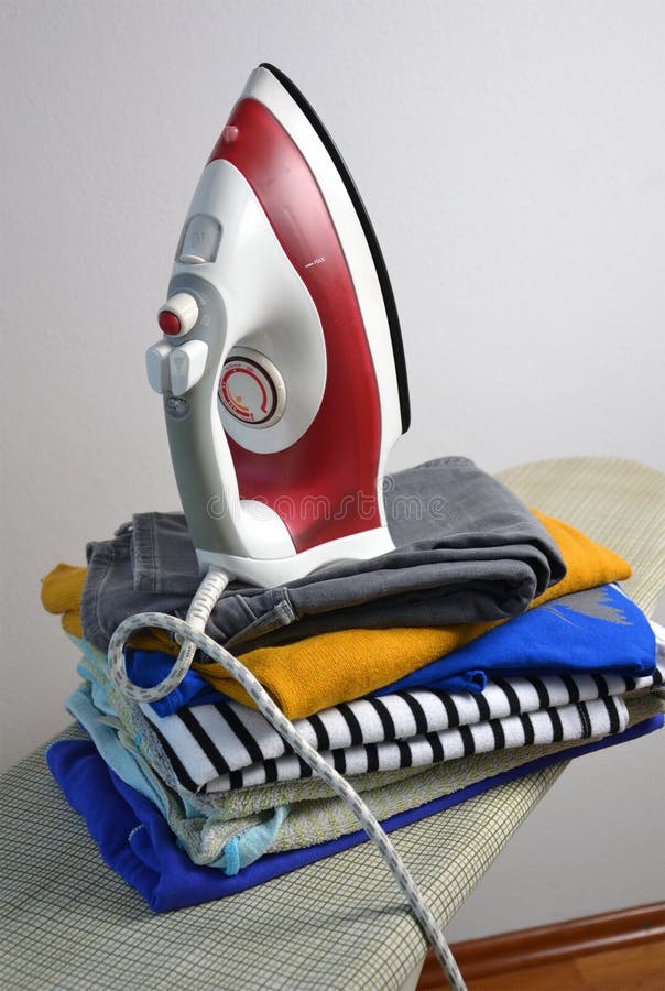 An Iron with Ironed Laundry Stock Photo - Image of modern, housework ...