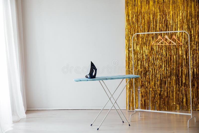 Iron and Ironing Board for the Care of Things in the Wardrobe Stock ...