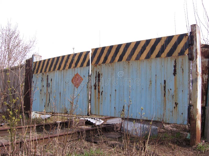 An Old Iron Fence with a Closed Rusty Gate Prohibits Travel To the ...