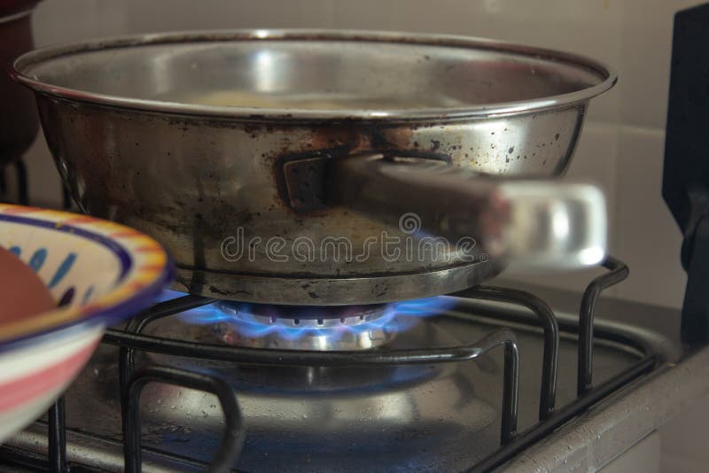Iron Pan Boiling Some Water with Pasta on a Stove with the Fire on ...