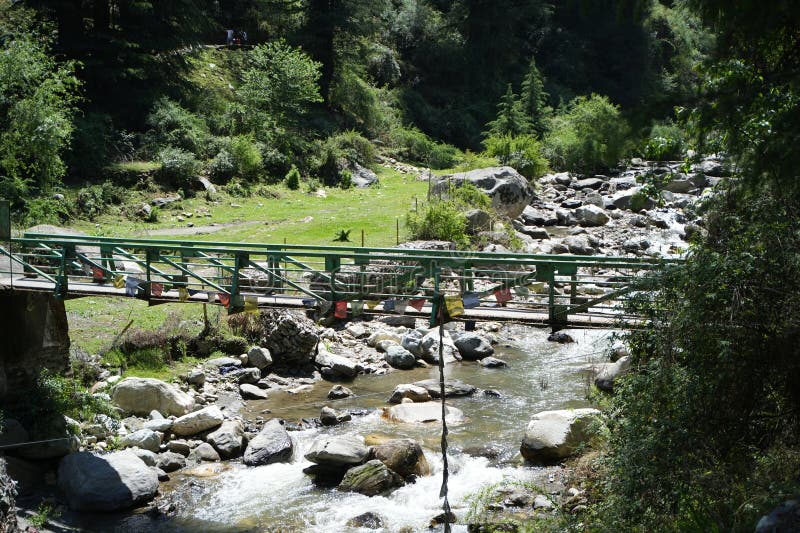 An Iron Pedestrian Bridge Over a Rushing River Stock Photo - Image of ...