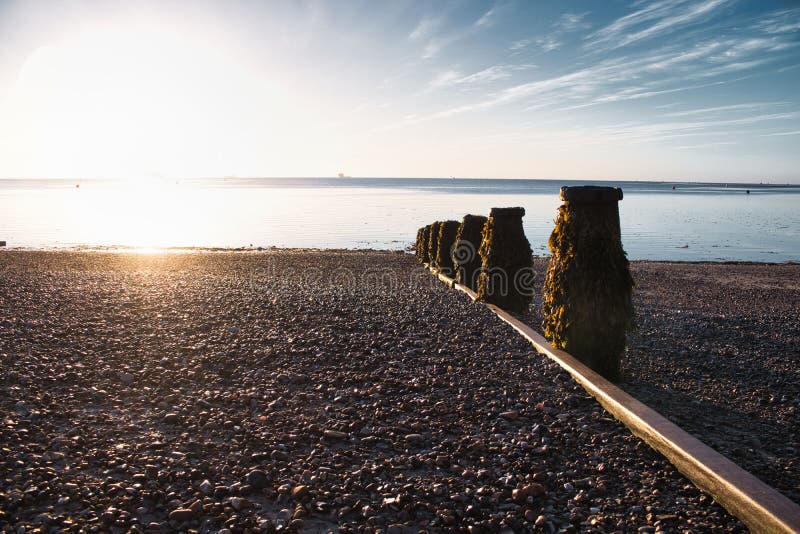 Iron Pillars on the Beach at Sunset Stock Photo - Image of nature, iron ...