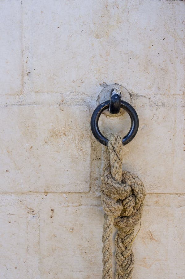 The Iron Ring in the Wall with a Rope Tied. Stock Image - Image of ...
